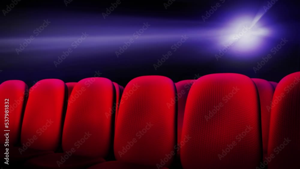 Cinema theater, red, empty seats in front of the projector's light ...
