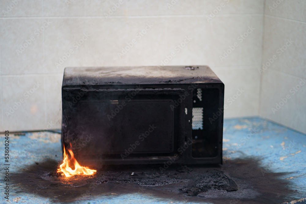 microwave oven on fire. the concept of fire in the kitchen and ...