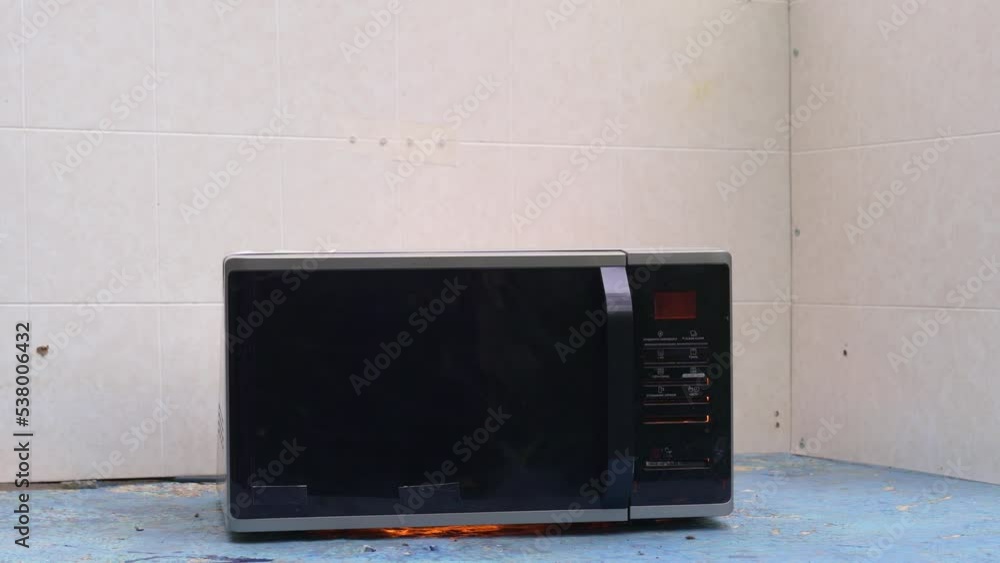 microwave oven on fire. the concept of fire in the kitchen and ...