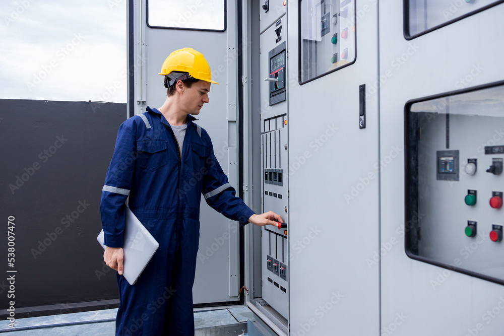 Electrical engineer working in control room. Electrical engineer man ...