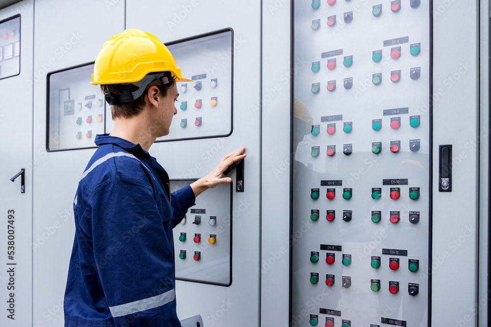 Electrical engineer working in control room. Electrical engineer man ...