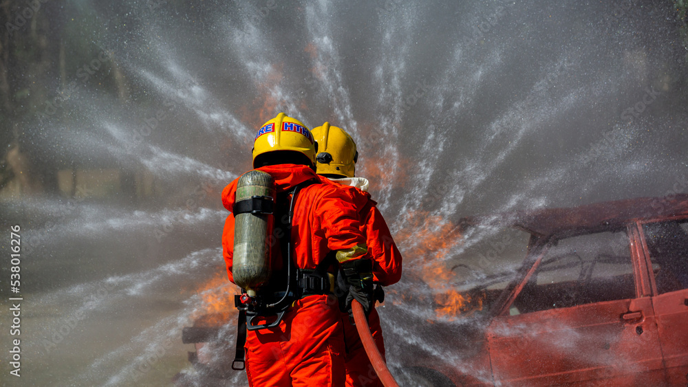 Asian firefighter on duty firefighting, Asian fireman spraying high ...