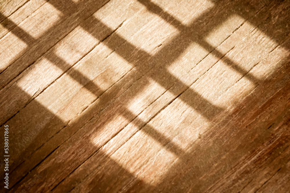 Shadow and light from the window with sprues on the floor. There is a ...