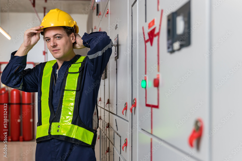Electrical engineer wearing helmet near Power Distribution Cabinet in ...