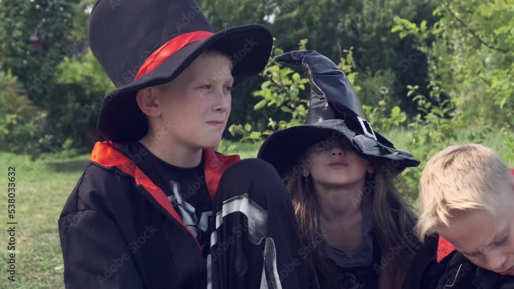 Children boy and girl in carnival costumes of witches and skeleton on ...