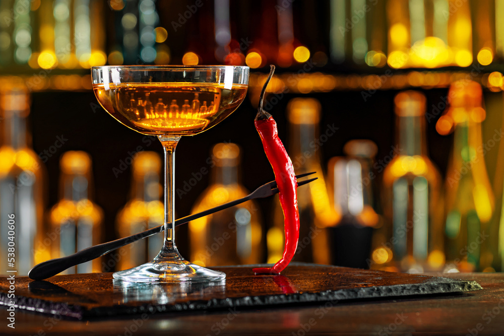 Cocktail with hot chilli pepper on bar counter in a restaurant, pub ...