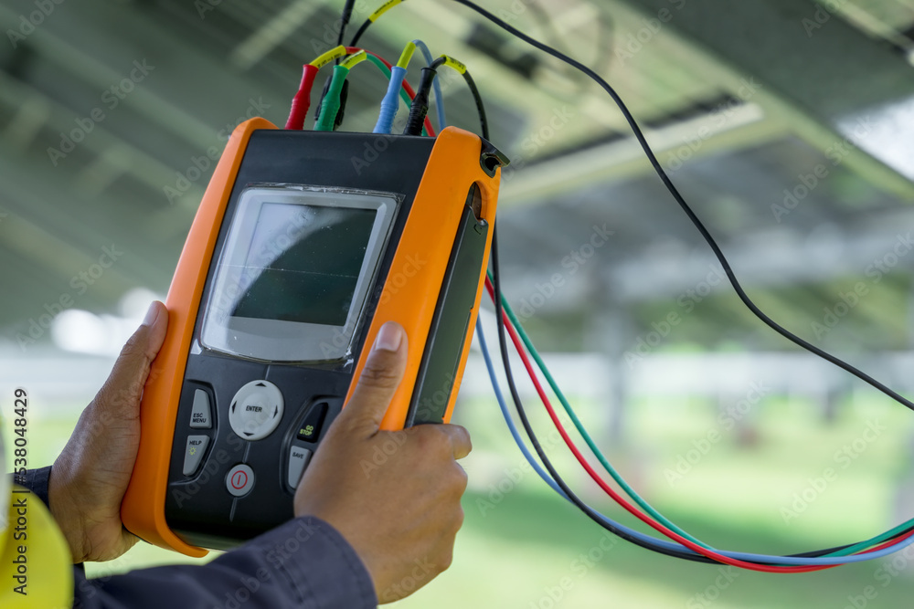 Engineers are checking the solar panels with a performance checker to ...