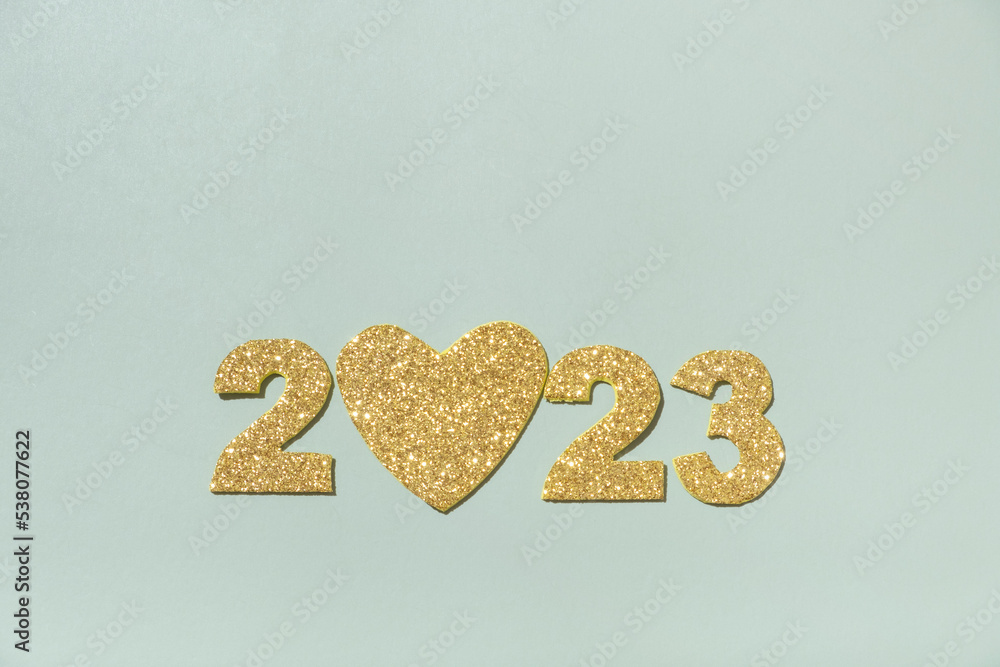 Shiny gold numbers 2023 on a pastel green background with a heart top ...