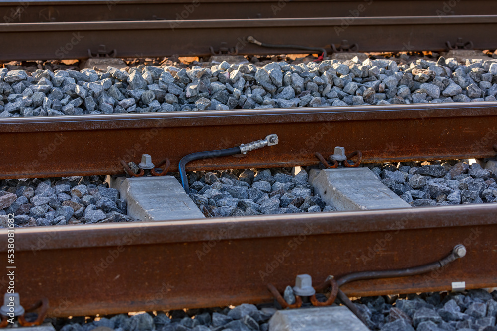 Rails of a railroad sleeper with press cable lugs for electrical ...