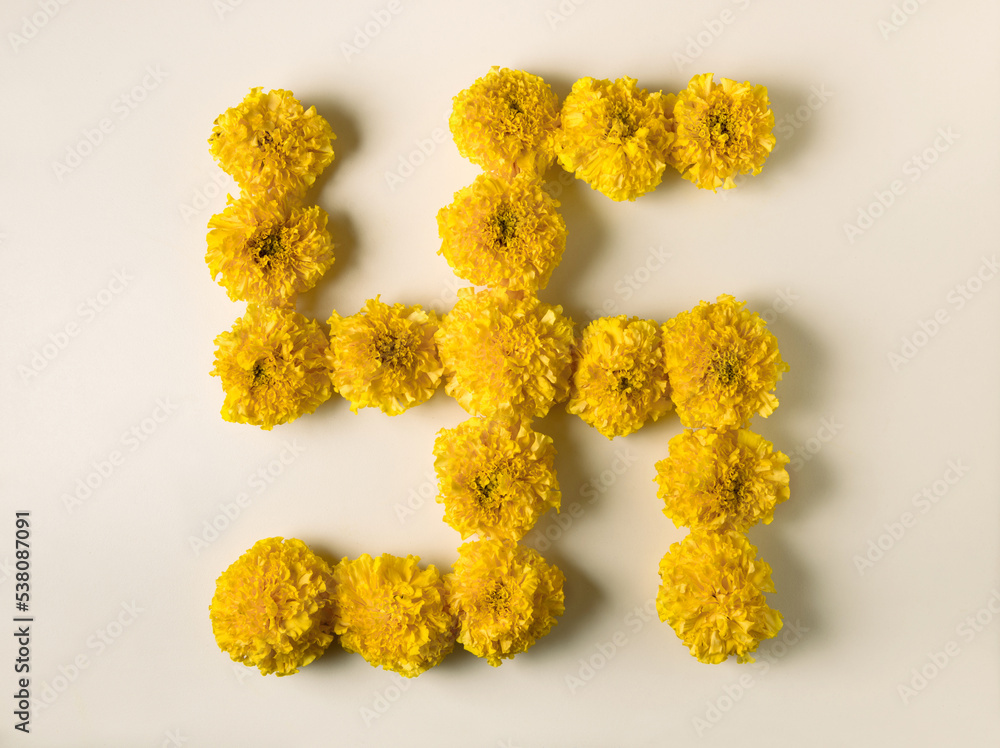 Swastika - a Hindu religious symbol made with fresh and bright golden ...