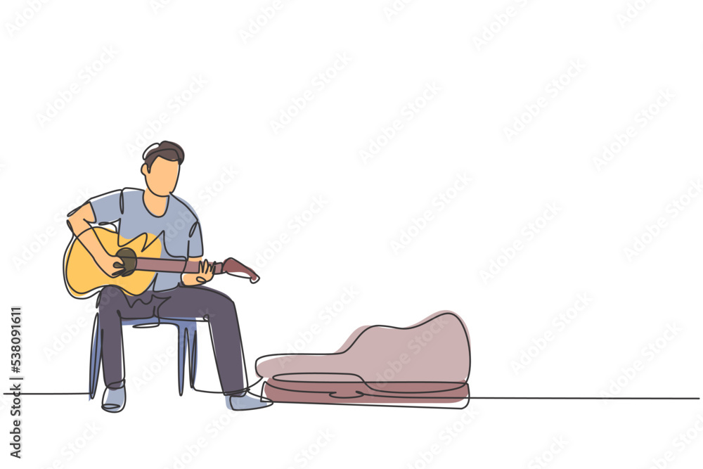 One continuous line drawing of young happy male guitarist sitting and ...