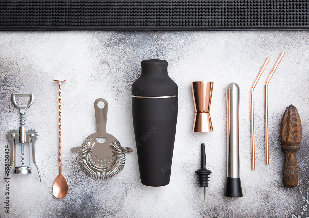 Various cocktail utensils.Copper jigger,straw and spoon with black ...
