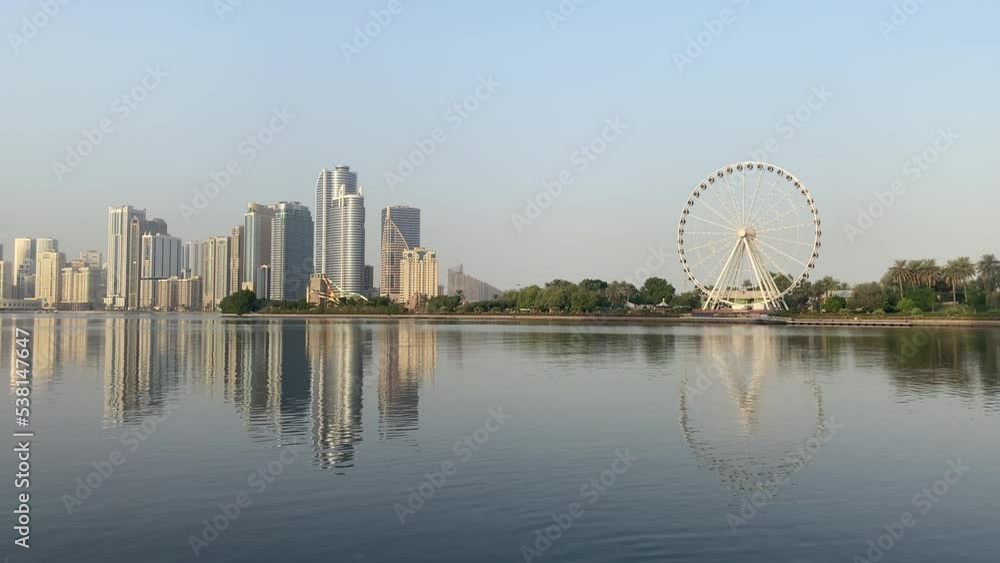 Eye of Emirates, giant wheel, Sharjah Skyline. Morning view of Sharjah ...