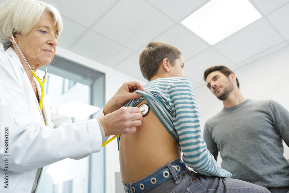 doctor examining a little boy with a stethoscope Stock Photo | Adobe Stock