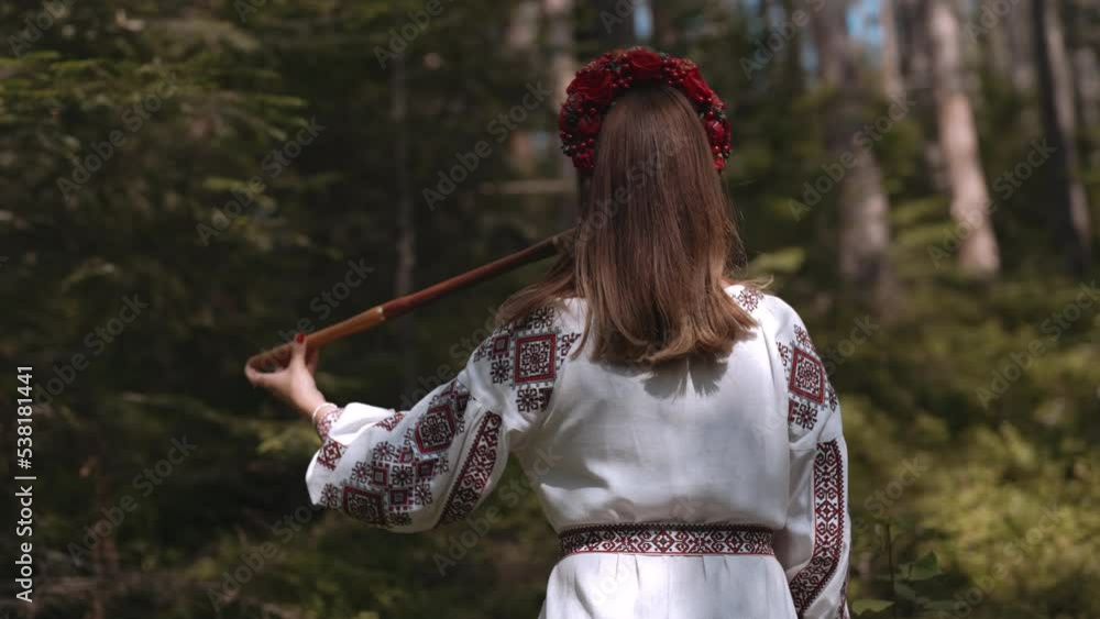 Woman playing on woodwind wooden flute - ukrainian telenka or tylynka ...