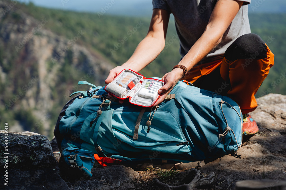 The guy demonstrates the contents of the first aid kit, a box with ...
