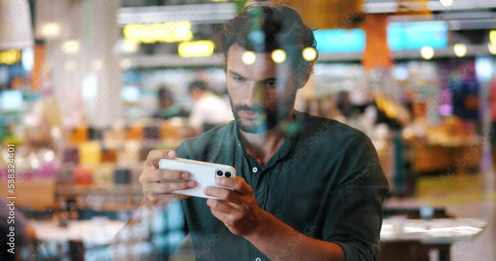 Excited addicted Caucasian man playing video games on his smartphone ...