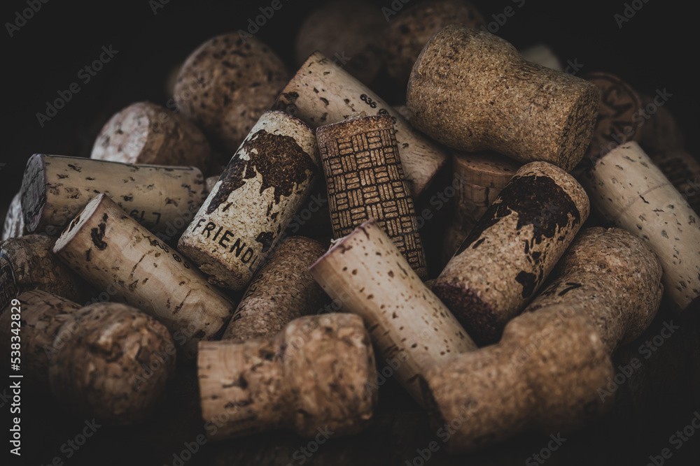 Two corks on a pile of used corks which show a world map and the word ...