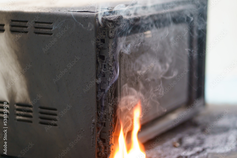 microwave oven on fire. the concept of fire in the kitchen and ...