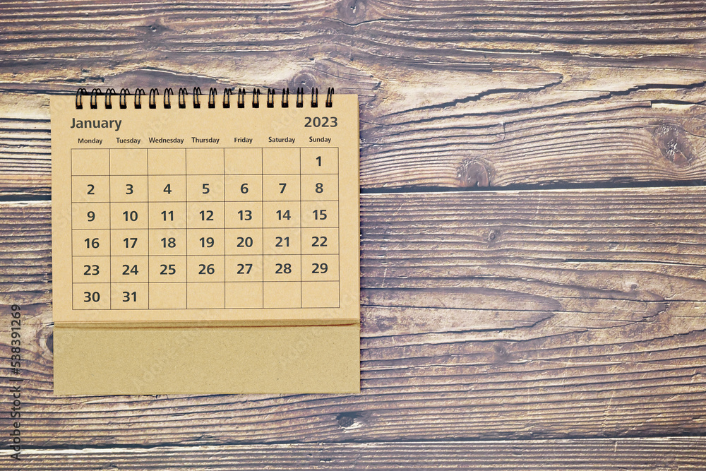 Top view of new year calendar January 2023 of yellow straw color on old ...