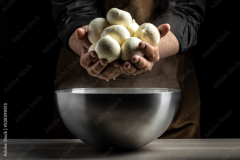 The homemade cheese maker produces handmade mozzarella with fresh bio ...