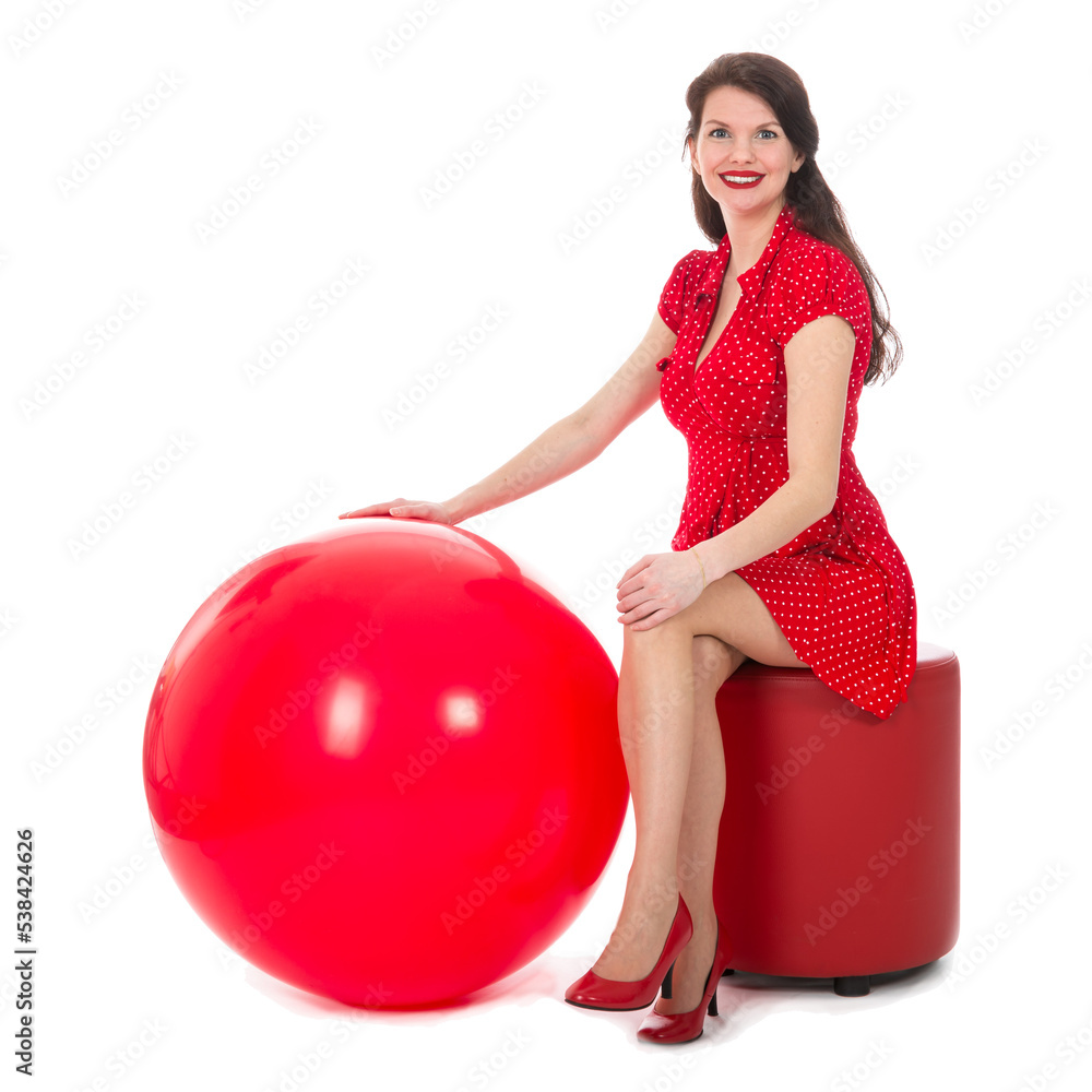 Beautiful woman sitting on footstool holding big red balloon isolated ...