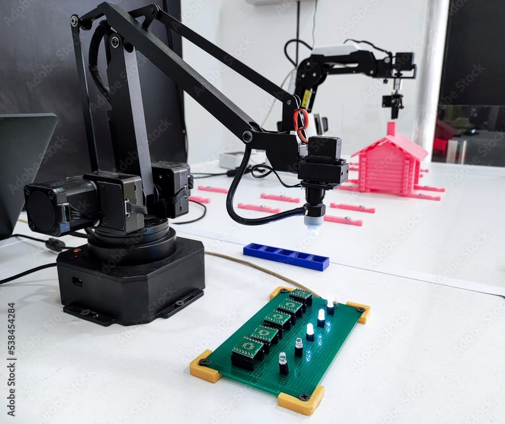 robot engineer, robotic arm on a light background. Engineer's ...