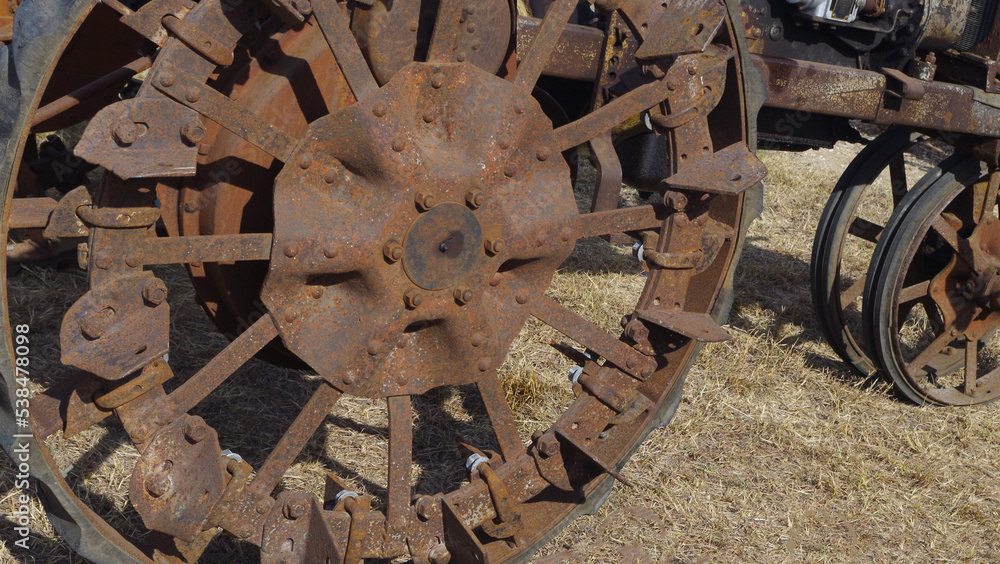 Old rusty 1930's metal tractor wheels with improvised rubber tread cut ...