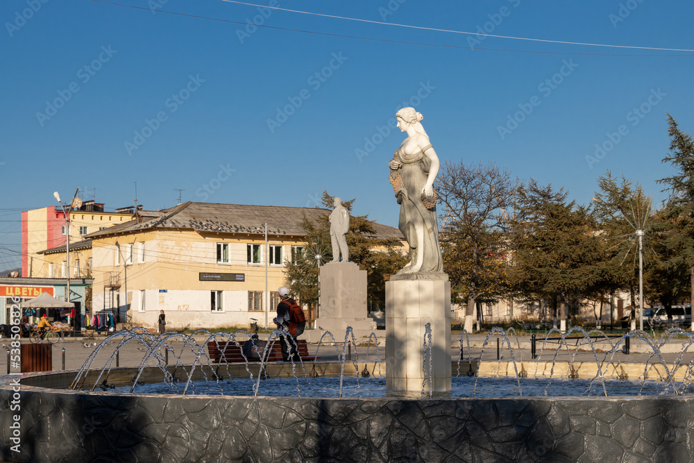 View of the fountain with a copy of the antique sculpture of a woman ...