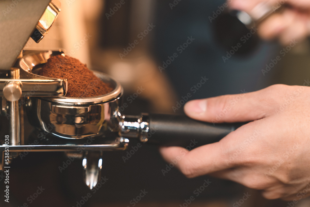 coffee beans ground and coffee powder pouring into holder with coffee ...