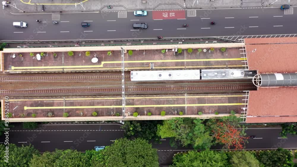 Passenger Train arriving and stopping at the platform, top down aerial ...