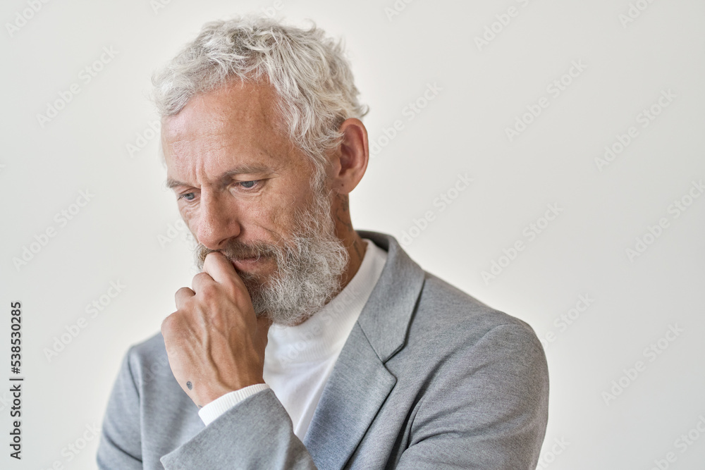 Thoughtful sad older business man investor, frustrated depressed middle ...