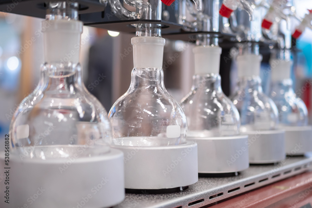 Laboratory equipment - empty glass vials on heating mantle in row ...