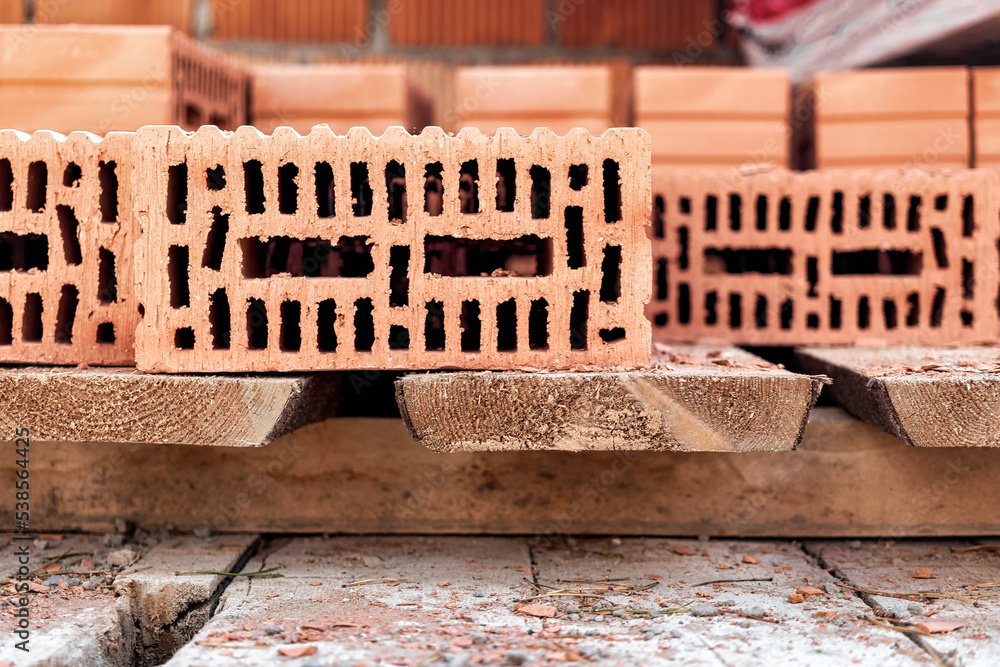 Red ceramic bricks at the construction site. Keramoblock. Hollow brick ...
