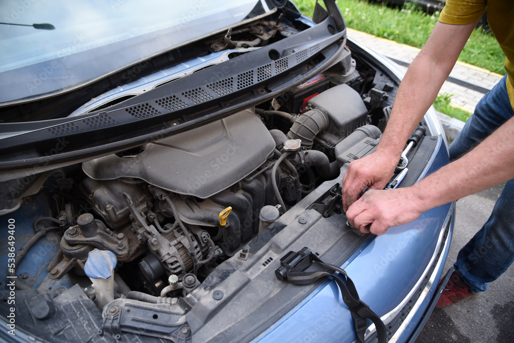 The open hood of the car with a view of the engine and the mechanisms ...