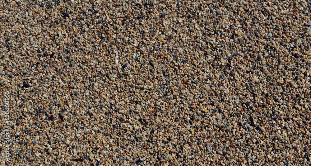 Texture of coarse sea sand close-up, small pebbles. For design ...