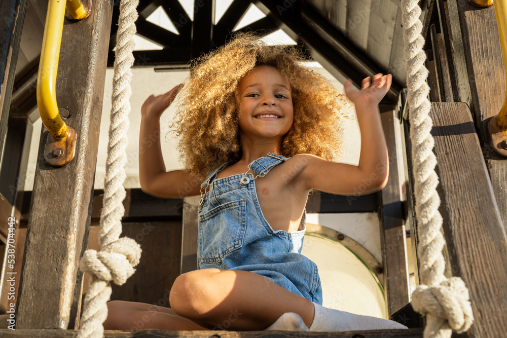 Playful little child girl portrait in the park, smiling and playing at ...