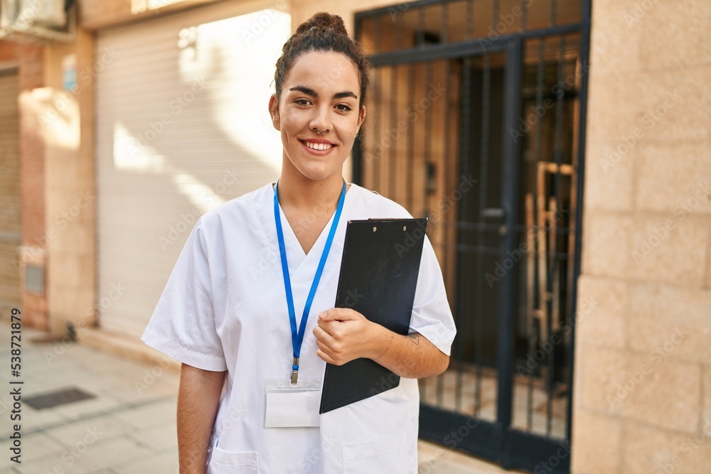 Young beautiful hispanic woman physiotherapist smiling confident ...