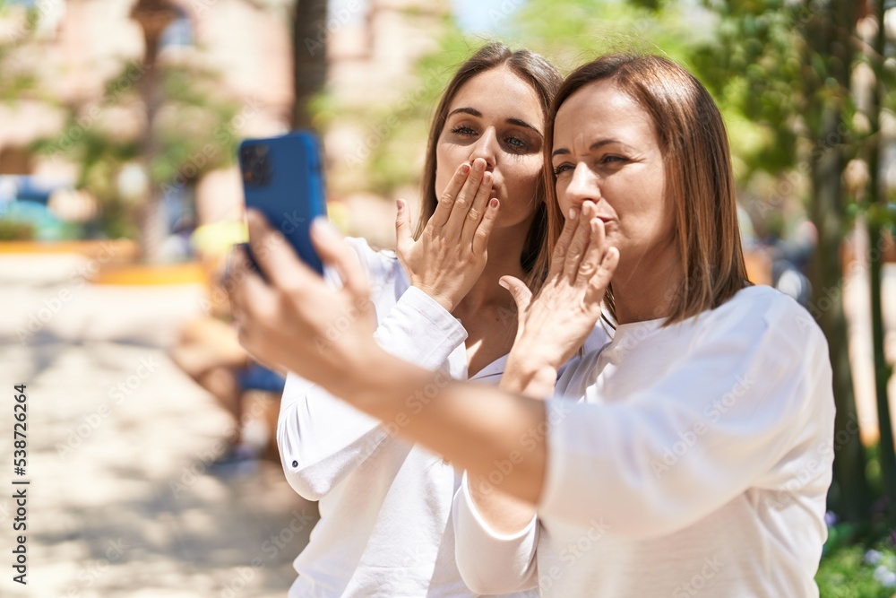 Two women mother and daughter having video call at park Stock Photo ...