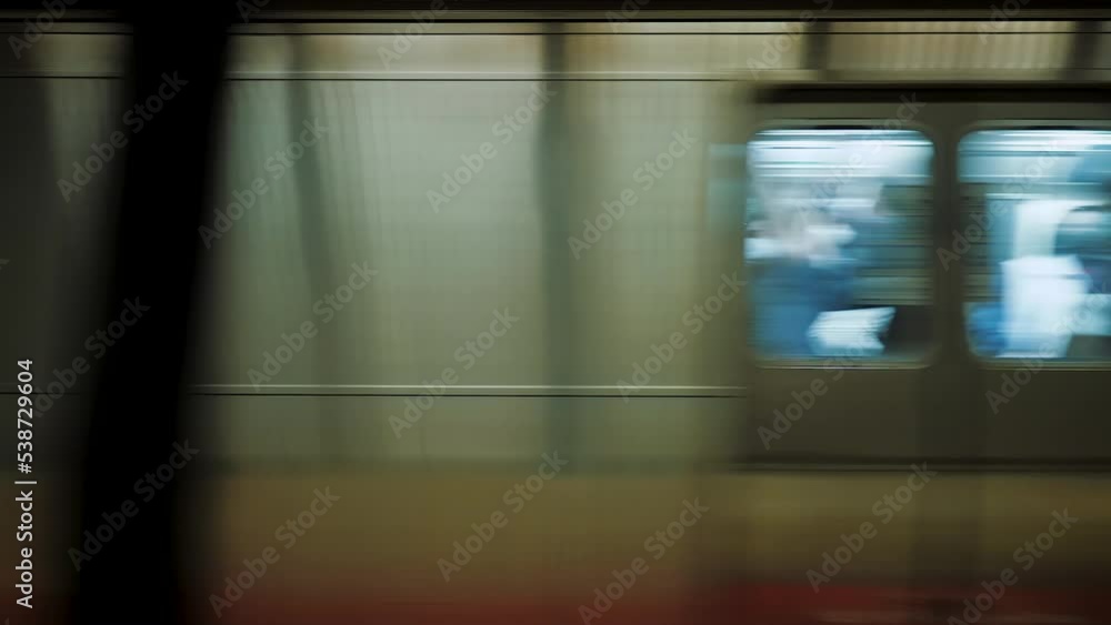 Subway train with people inside moving fast from metro station, close ...