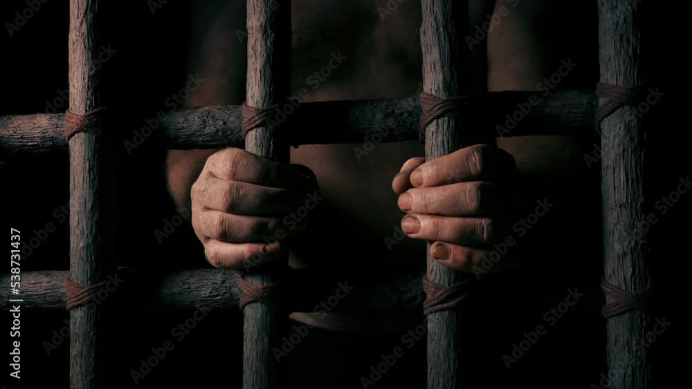Imprisoned Man Holds Bars In Ancient World Setting Stock Video | Adobe ...