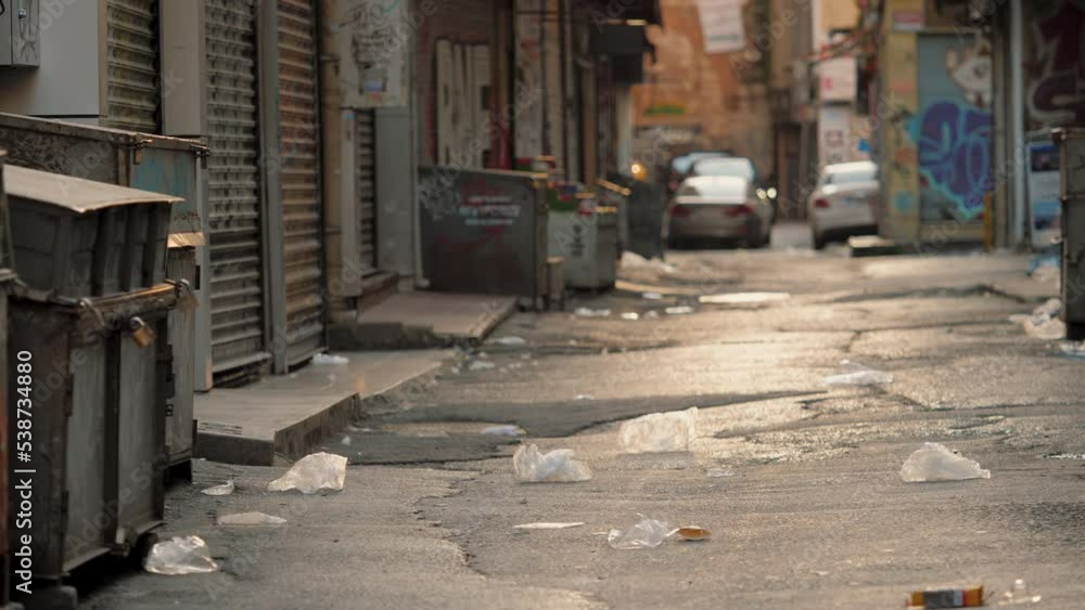 Empty backstreet with trash or garbage on the ground, street with no ...
