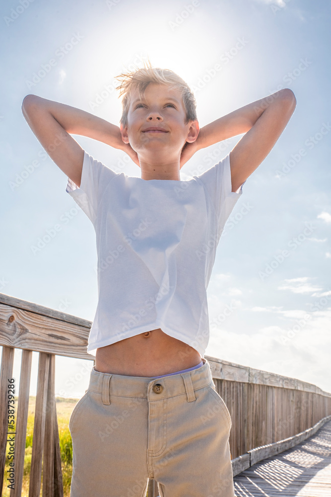 Child Youth Boy Standing in the Sun on a Boardwalk Stock Photo | Adobe ...