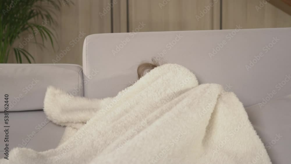 CLOSE UP: Young lady getting scared while watching horror movie on ...