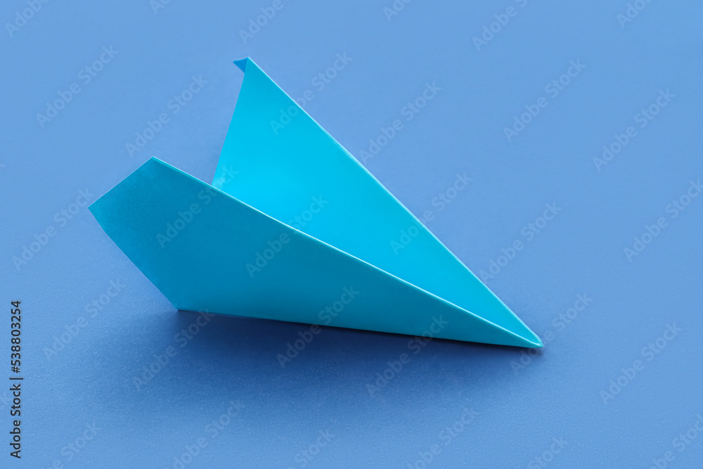 Blue paper plane on color background Stock Photo | Adobe Stock