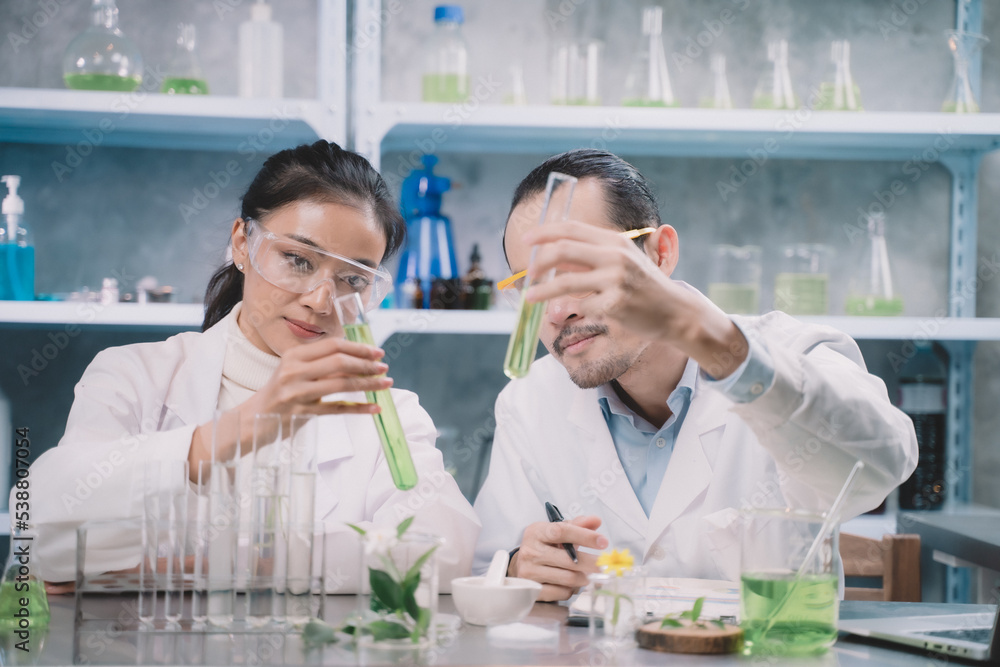 Two research people are comparing and discuss information about ...