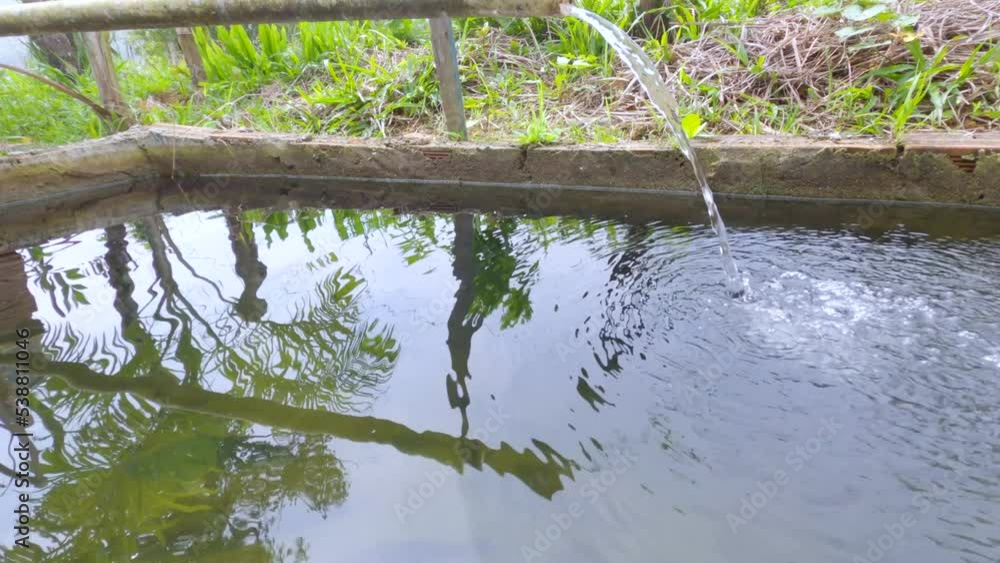 Water falling into the fish tank to oxygenate the tank. Water pipe ...