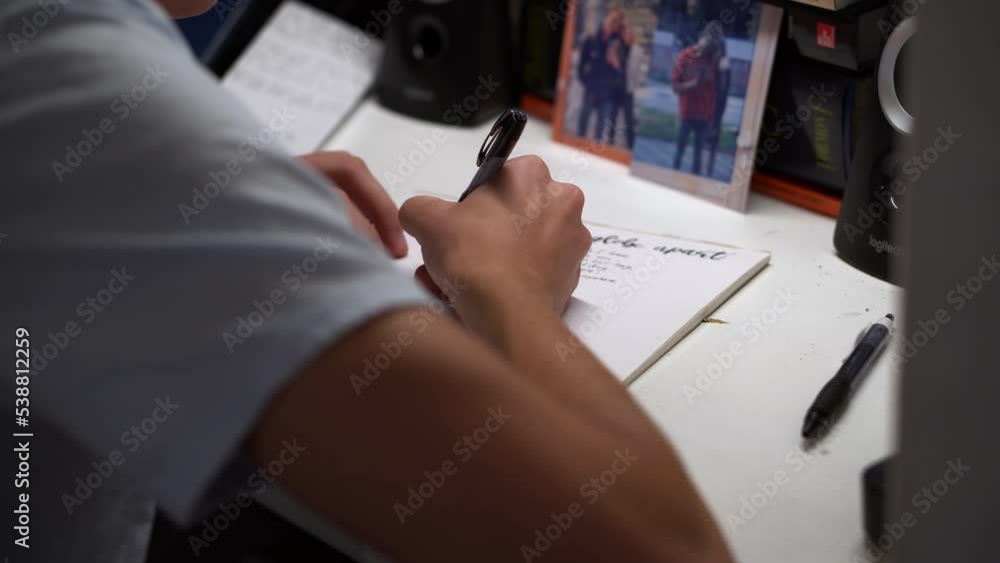 Arm Of A Young Man With Hand Writing Notes On The Desk In Study Room ...
