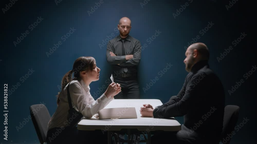 Female detective shows to suspected criminal photo of evidence from ...