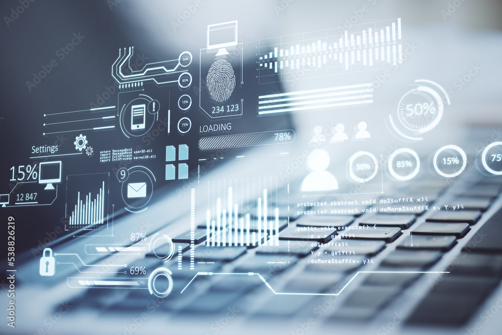 Close up of laptop with creative glowing business chart interface hologram on blurry background ...